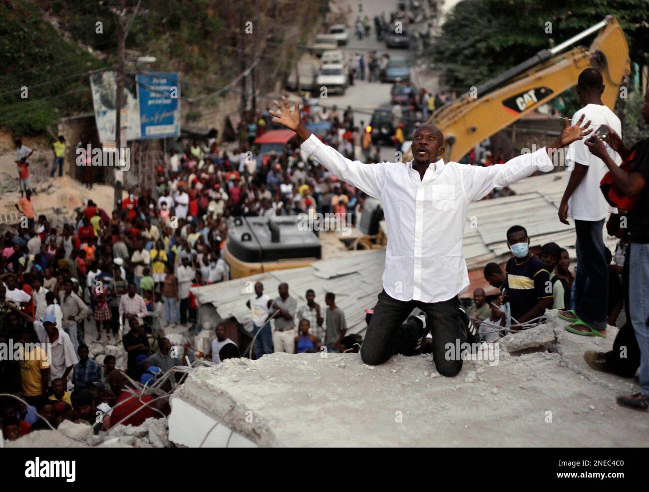 Johnny Julien prays as French rescuers search for a possible survivor ...