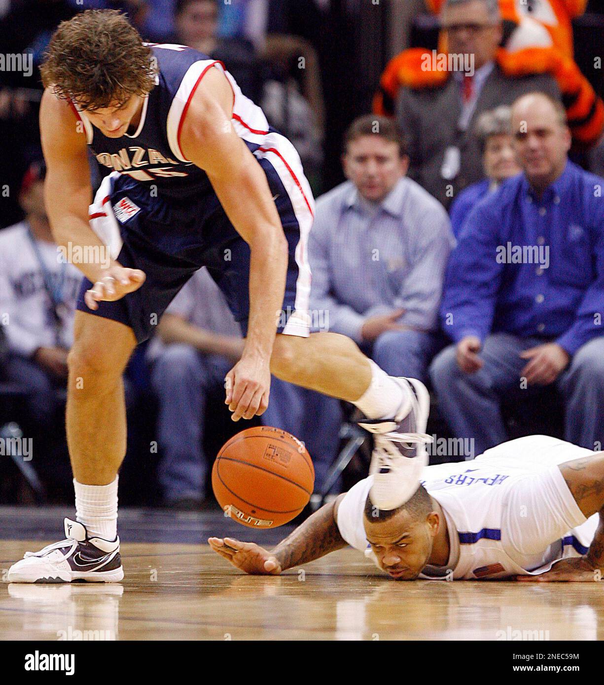 Memphis forward Pierre Henderson-Niles, bottom, lands on the floor as ...