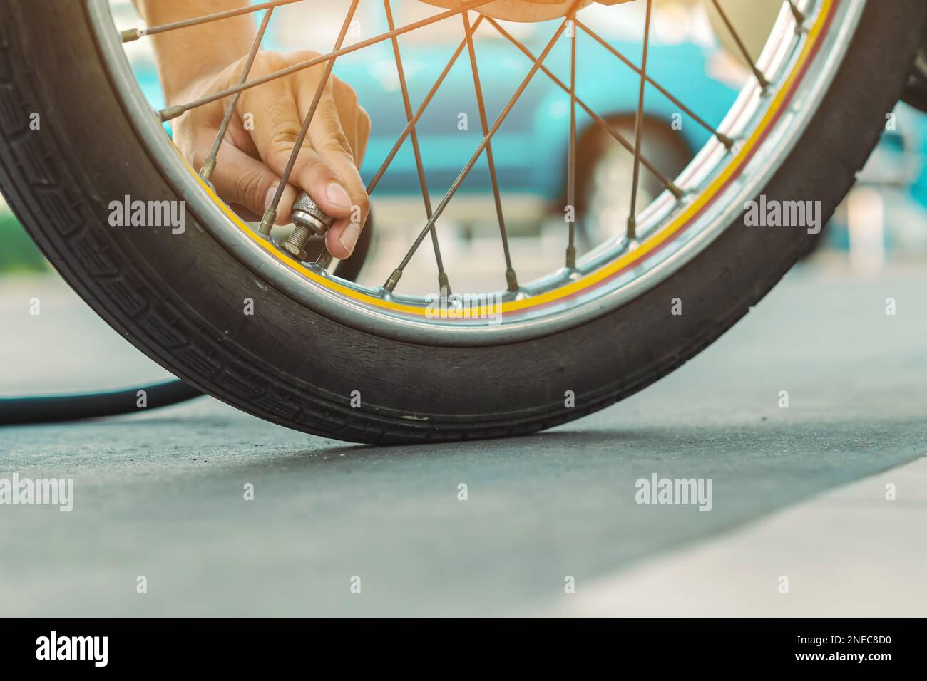 Hands of man check inflator pressure and inflates a tire on motorcycle ...