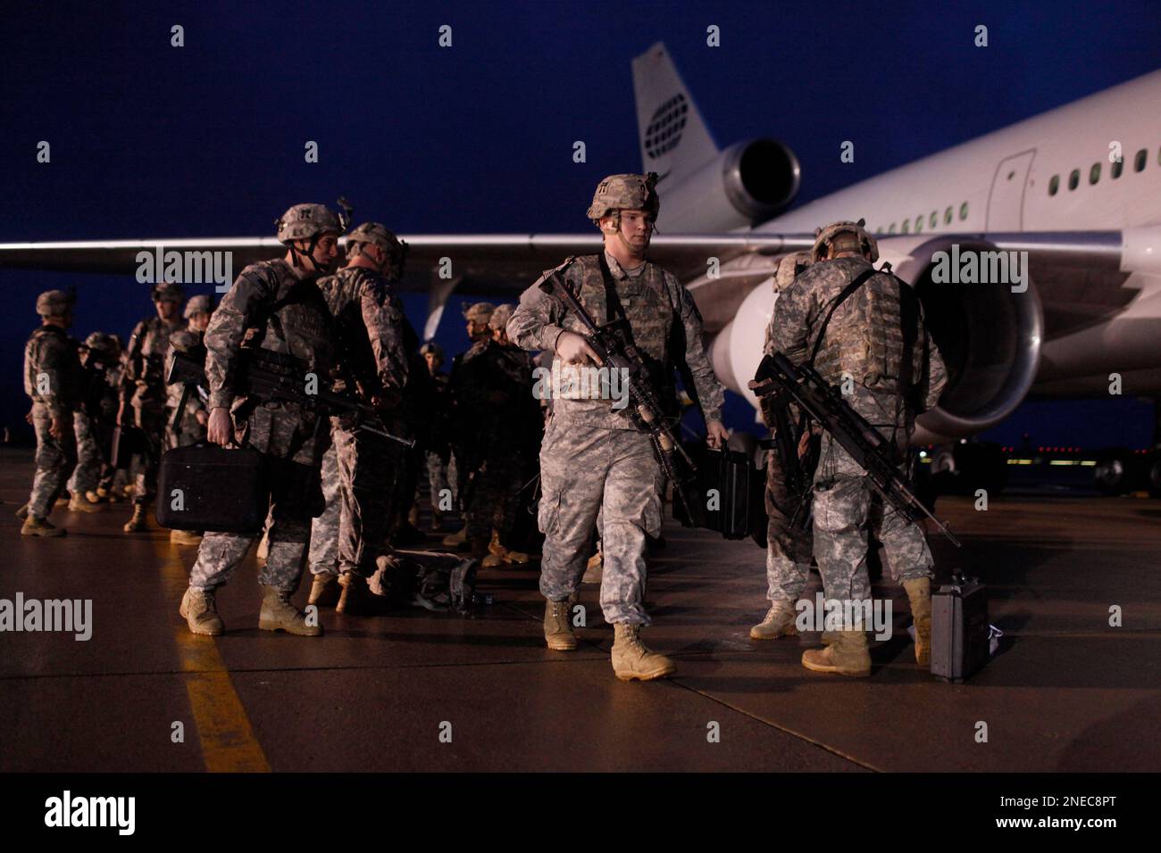 Soldiers wait to board a plane to Afghanistan during a deployment at ...