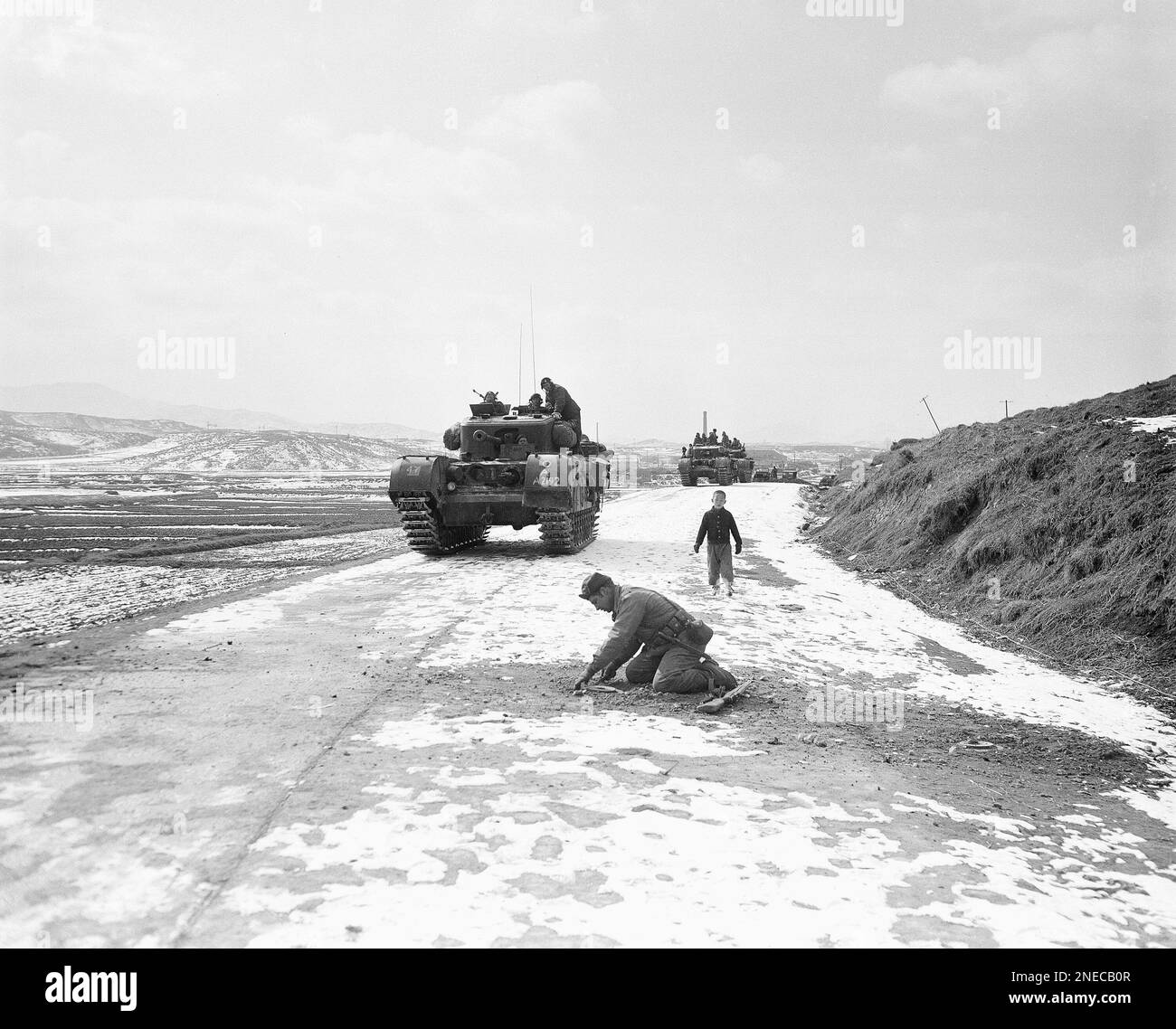 A British Churchill tank, foreground and other allied armor are held up ...