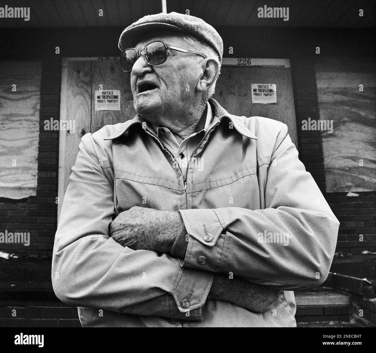 Tom Gerrity, 75, stands outside boarded up homes on the block where he ...