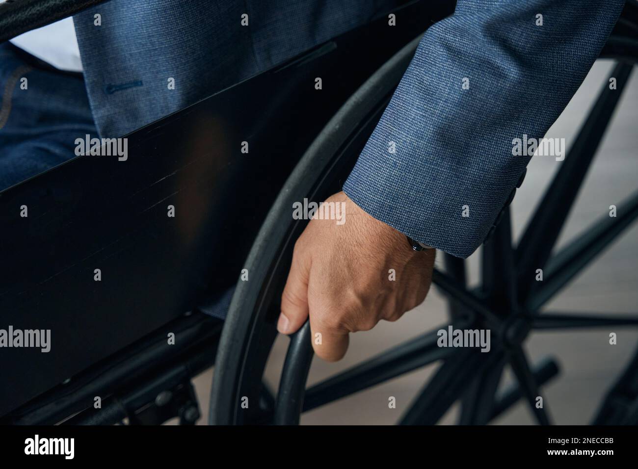 Close-up photo of male hand on the wheel of wheelchair Stock Photo - Alamy