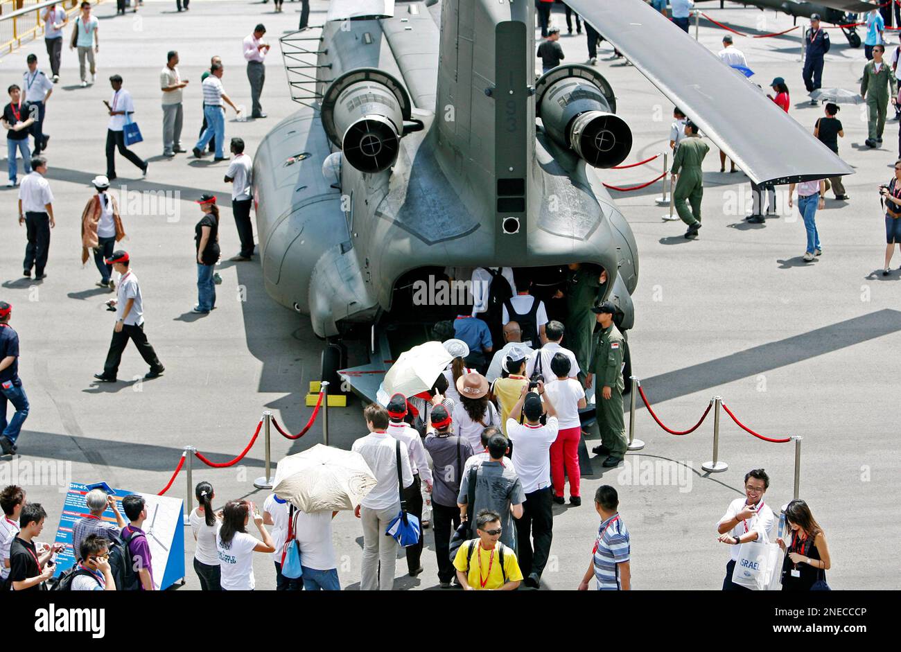 Trade show visitors enter the rear of a Singapore Armed Forces Chinook ...
