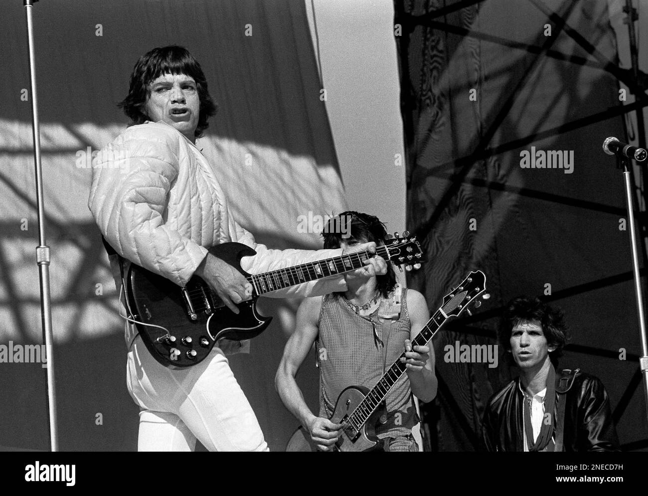 Mick Jagger of the Rolling Stones rock group swings back and forth ...