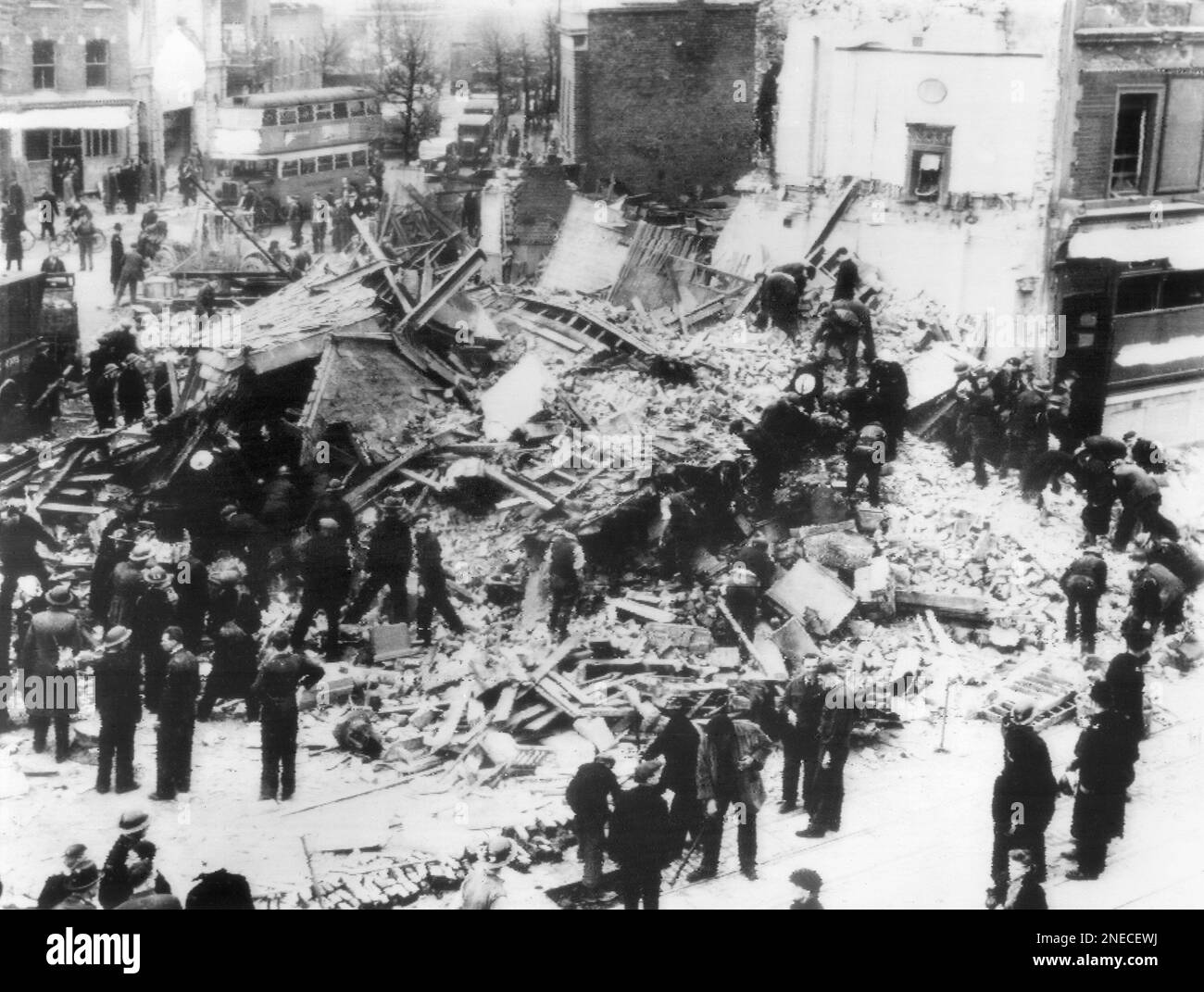 Rescue workers search the wreckage of a London bank demolished in the ...