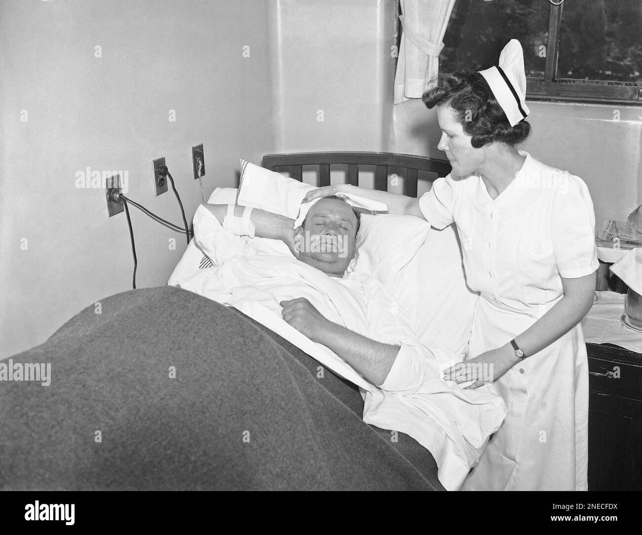 Nurse Alice Barrow watches detective Martin Schuchman of Queens, one of ...