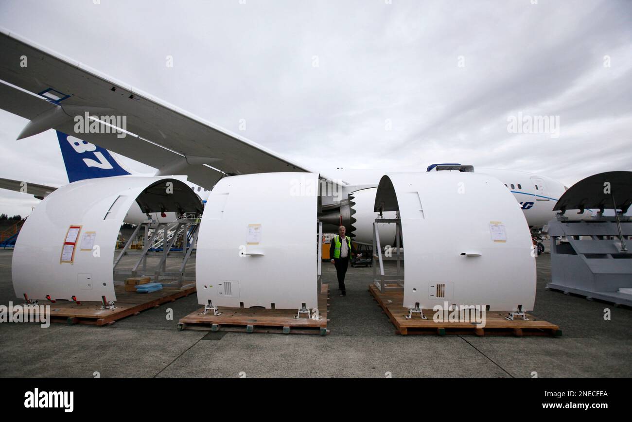 Pieces of the engine cover sit next to the first Boeing 787 with the ...