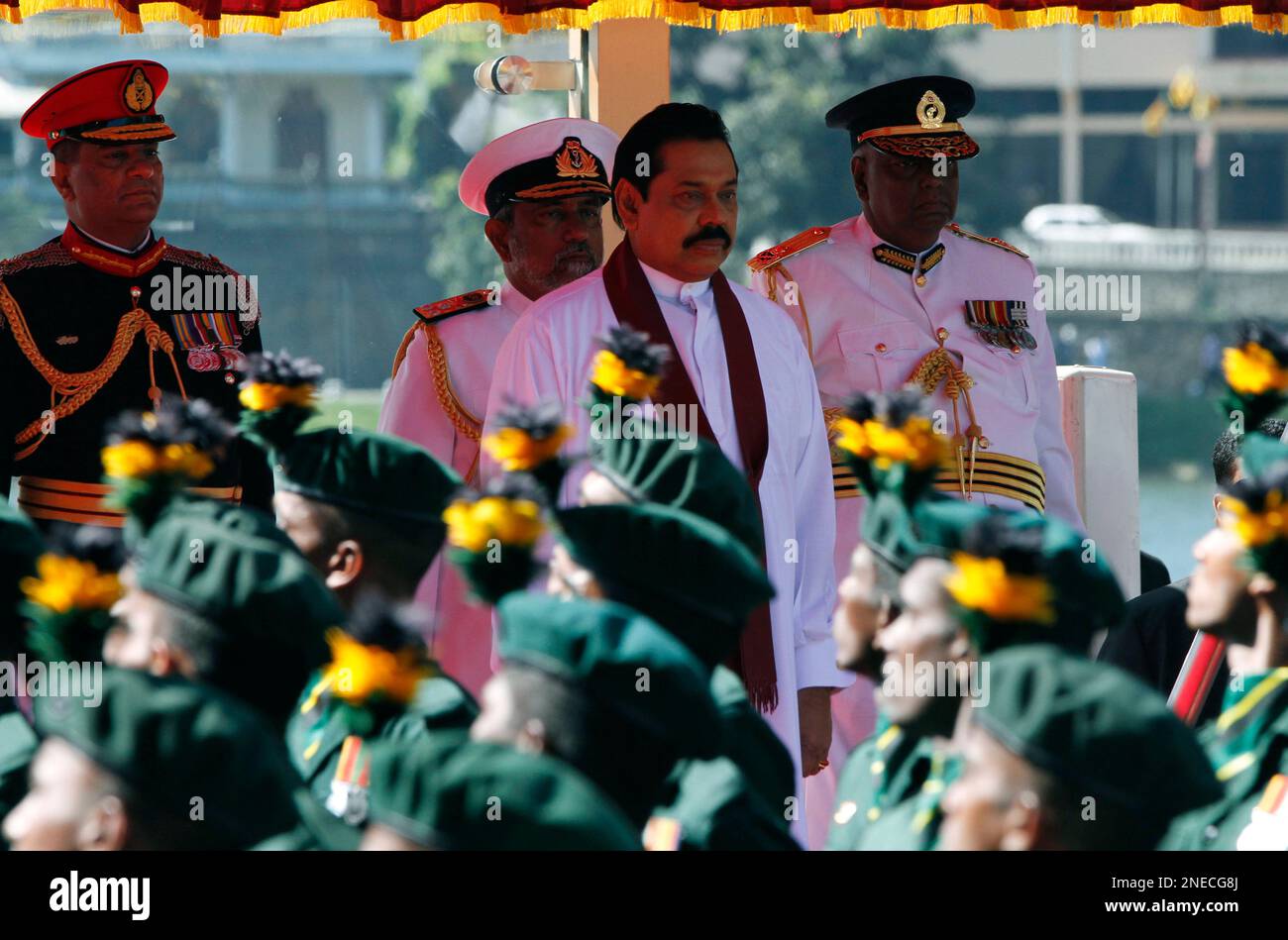 Sri Lankan President Mahinda Rajapaksa, center, inspects a parade, as ...
