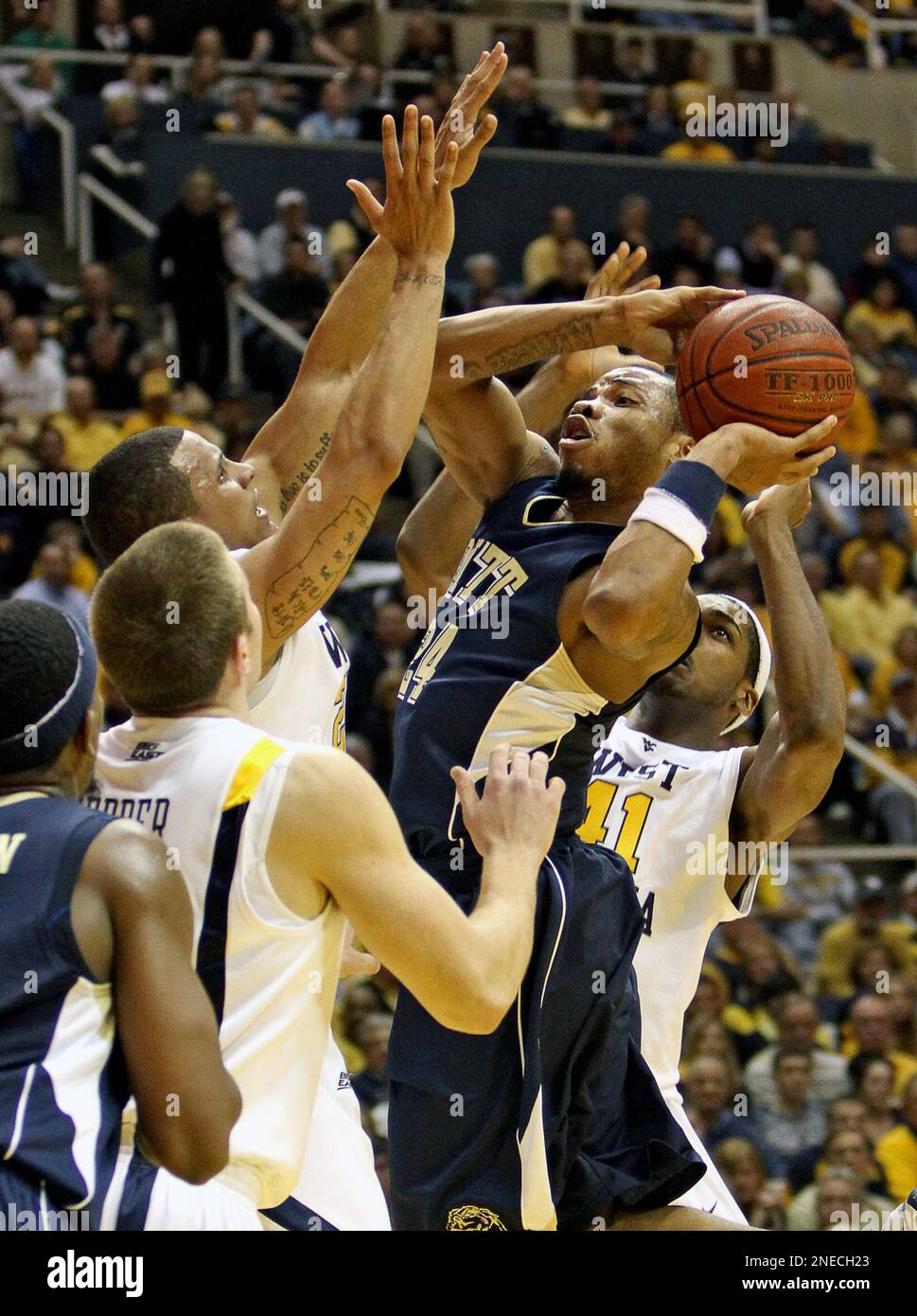 Pittsburgh's Jermaine Dixon, center, is defended by West Virginia's ...