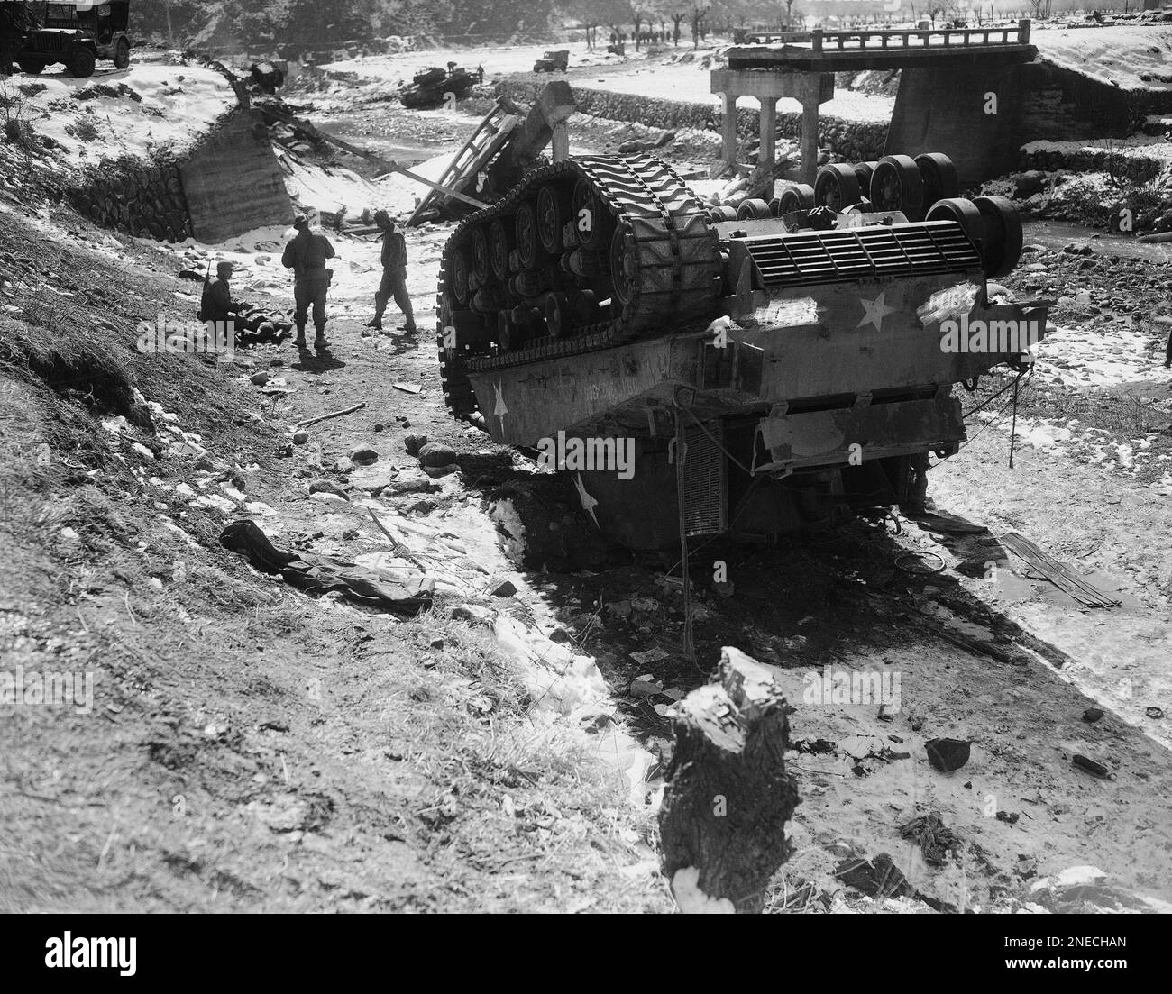 A dead GI and an overturned tank lie in ditch near Hoengsong on March ...