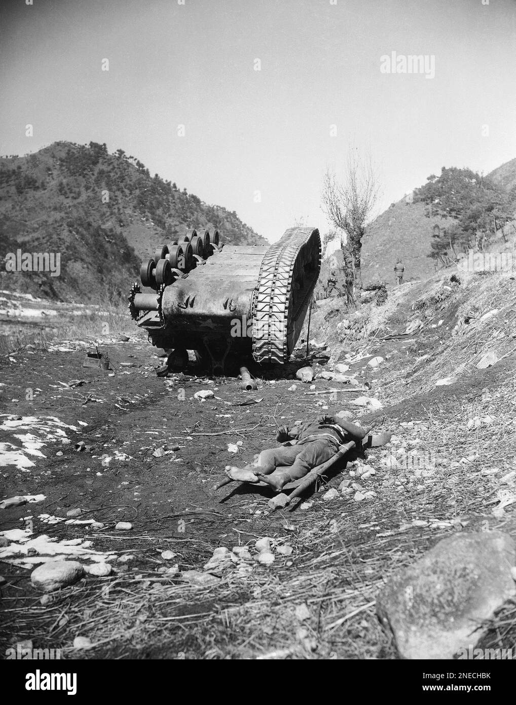 A dead GI and an overturned tank lie in ditch near Hoengsong on March ...