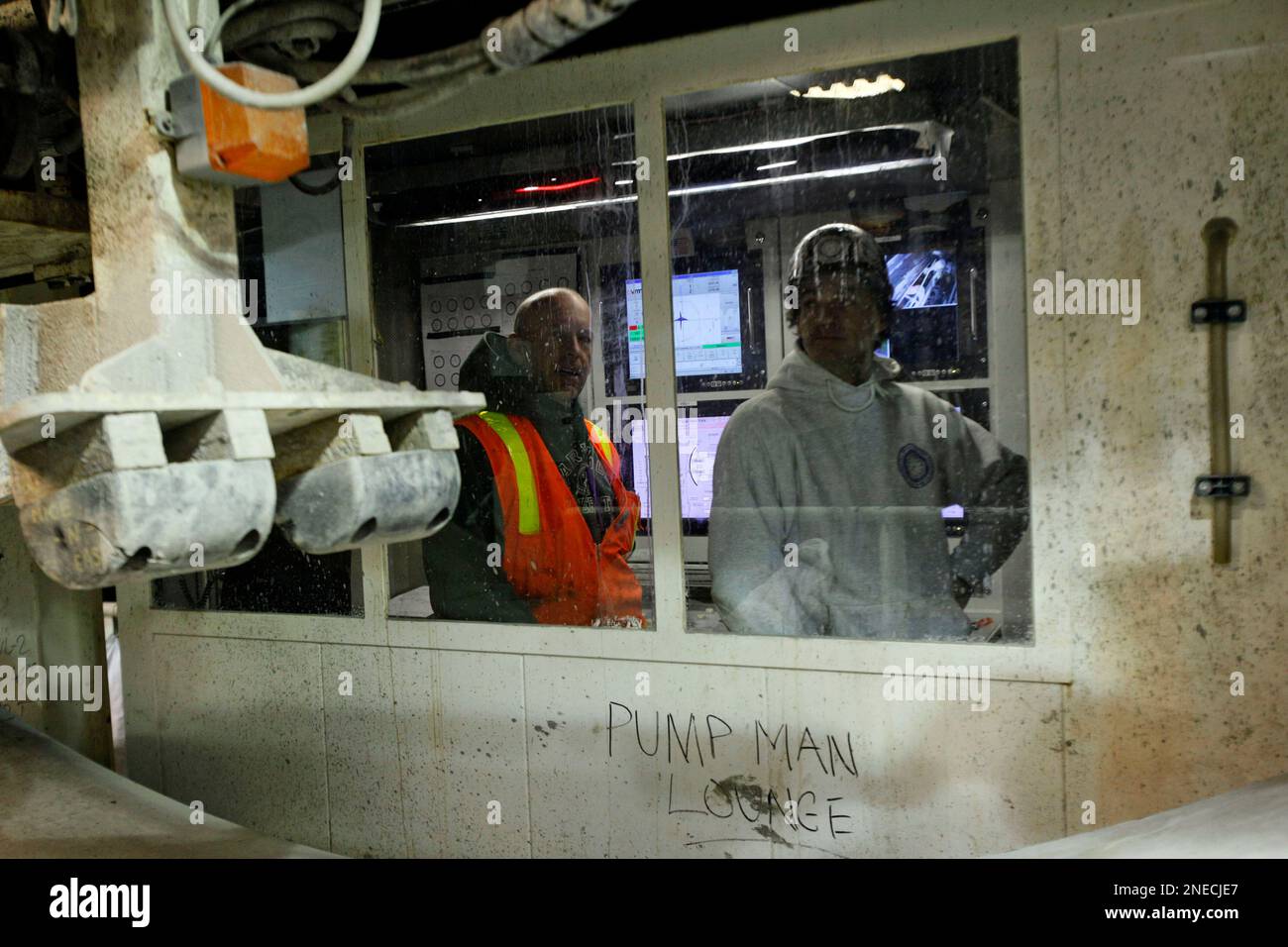 A engineers work inside the control room of the tunnel boring machine ...