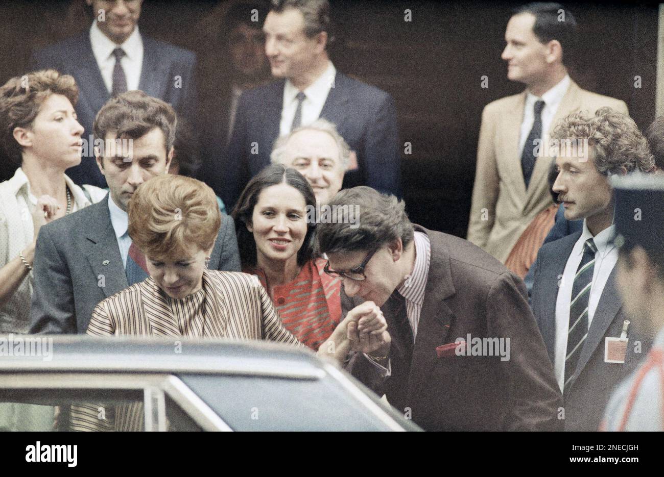 French couturier Yve Yves St. Laurent kisses the hand of Mrs. Raisa ...