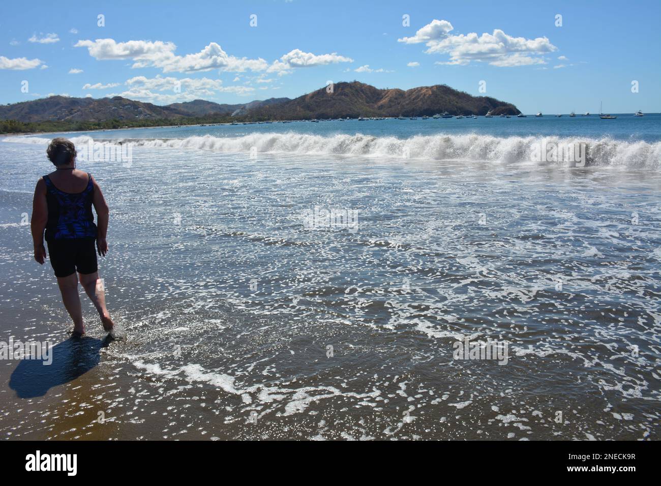 Solitary person walking along deserted beach at Playa de Coco ...