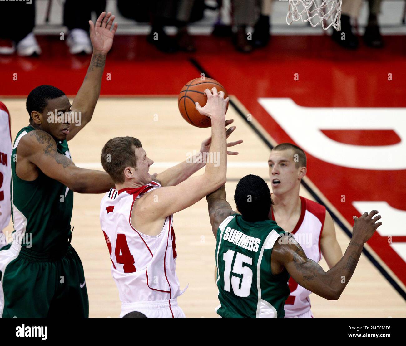 Wisconsin's Tim Jarmusz pulls in a defensive rebound away from Michigan ...