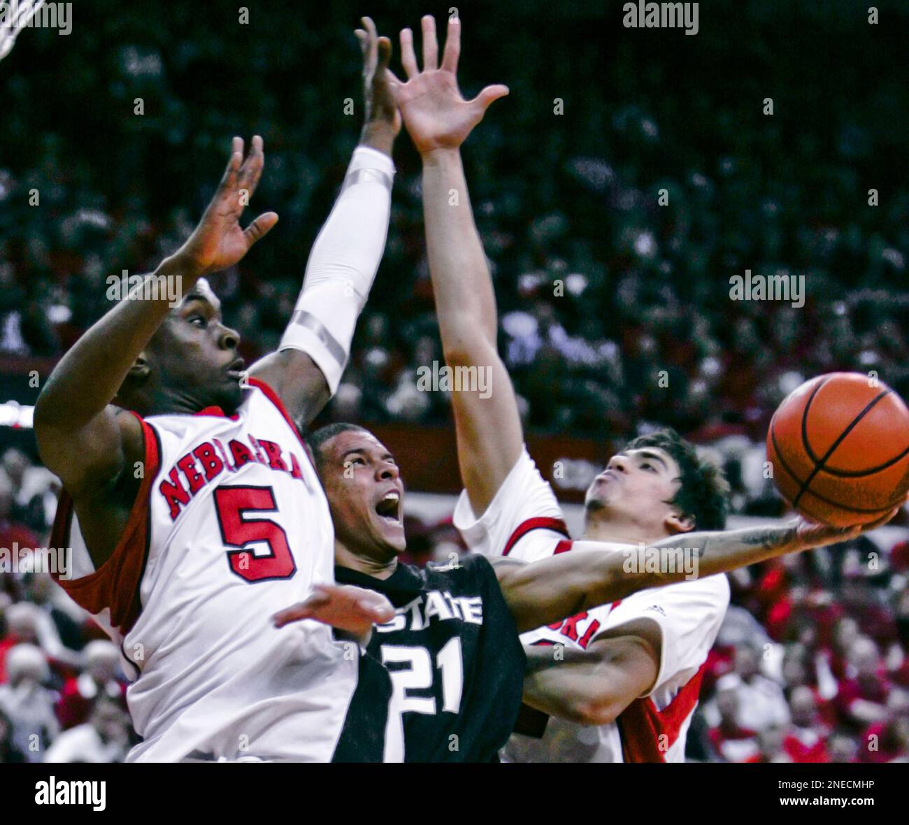 Kansas State's Denis Clemente (21) is defended by Nebraska's Sek Henry ...