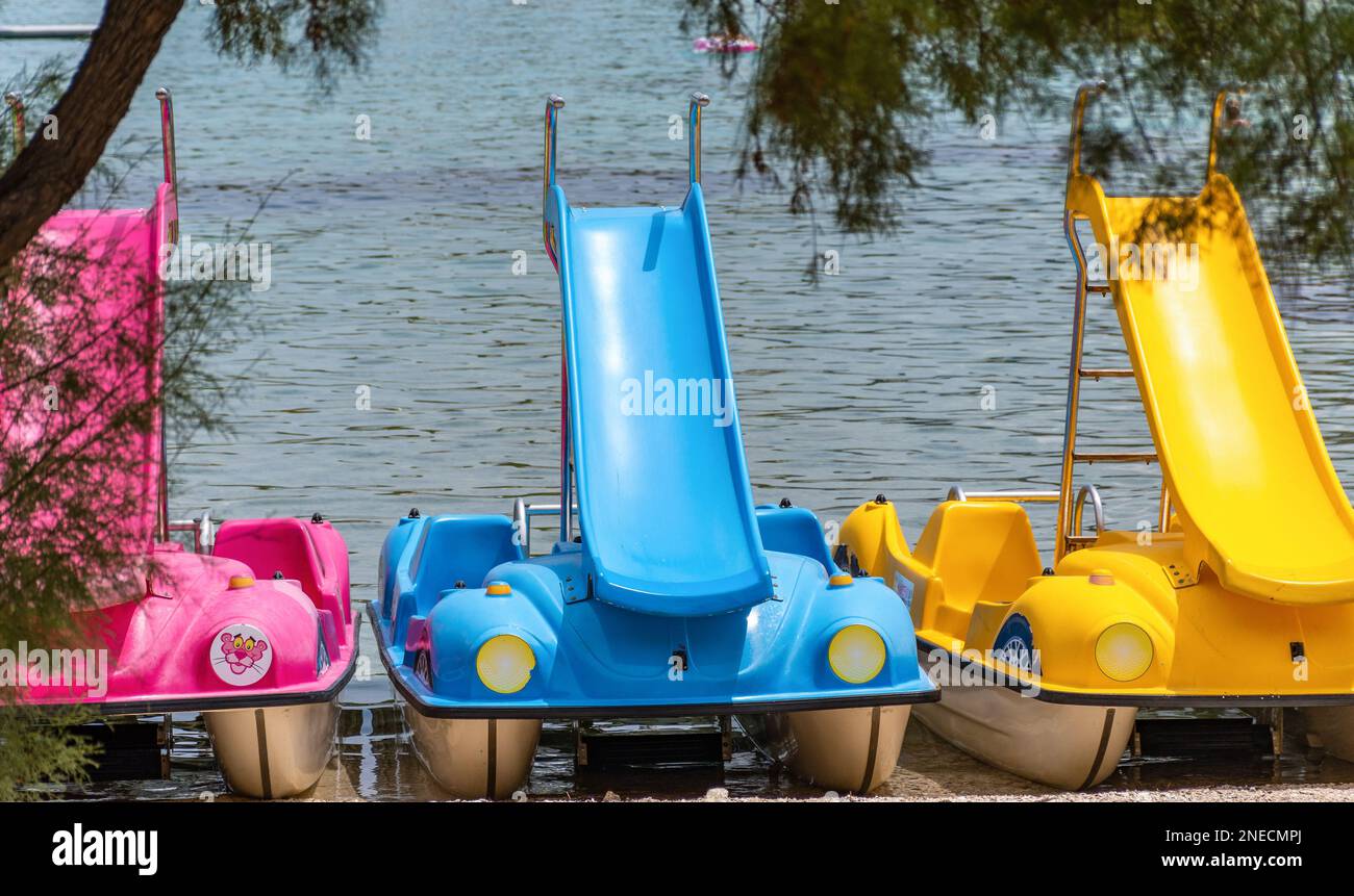 A view of colorful pedal boats on beach Stock Photo - Alamy