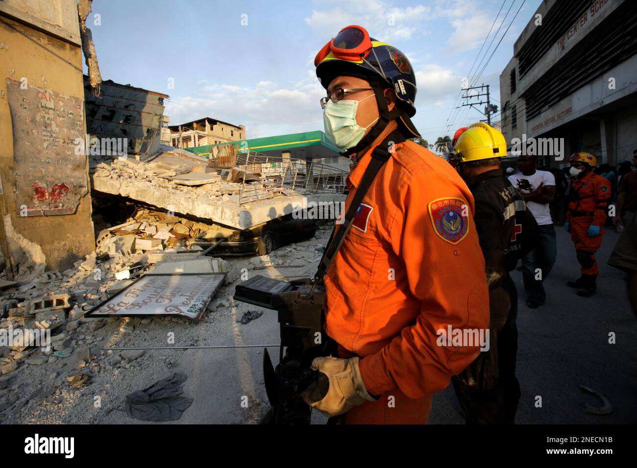 A man with Taipei City Search and Rescue stands among ruins in Port-au ...