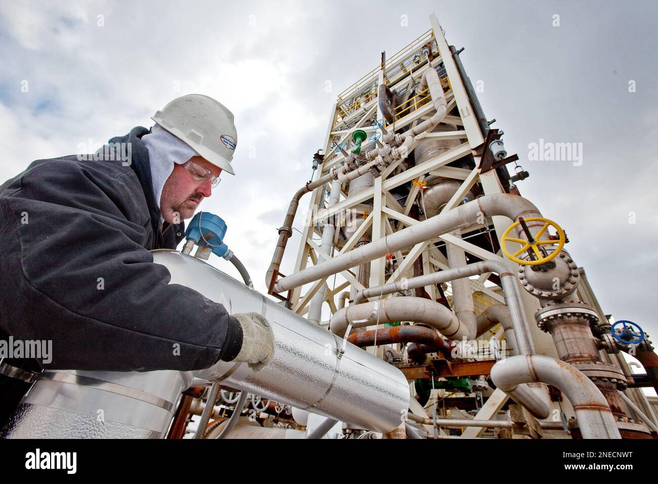 In a Tuesday, Dec. 29, 2009 photo, Dave Tucker installs insulation ...