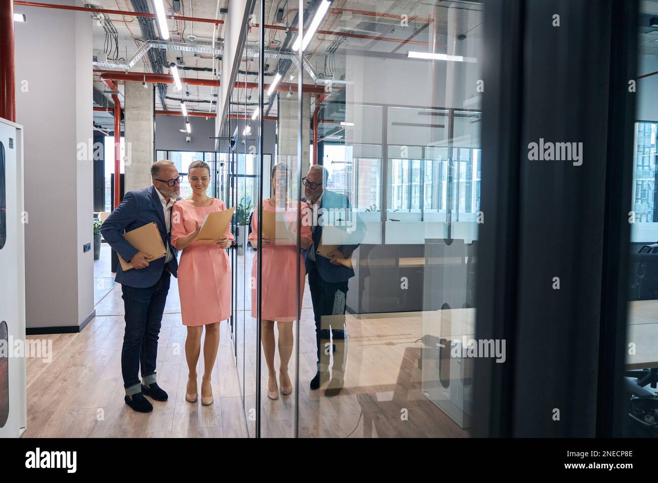 Couple employees business company looking through documents in office ...