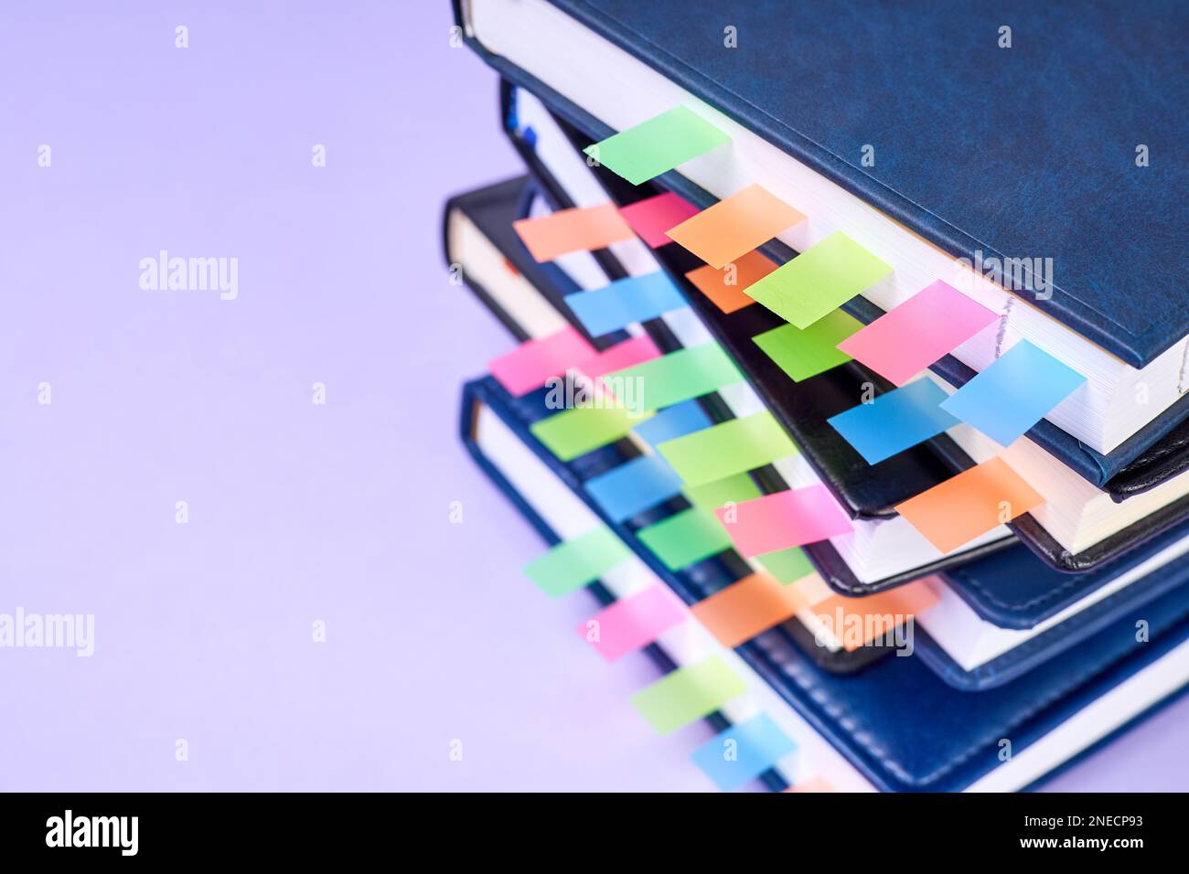 Close-up of a stack of office notepads with colorful sticky page ...