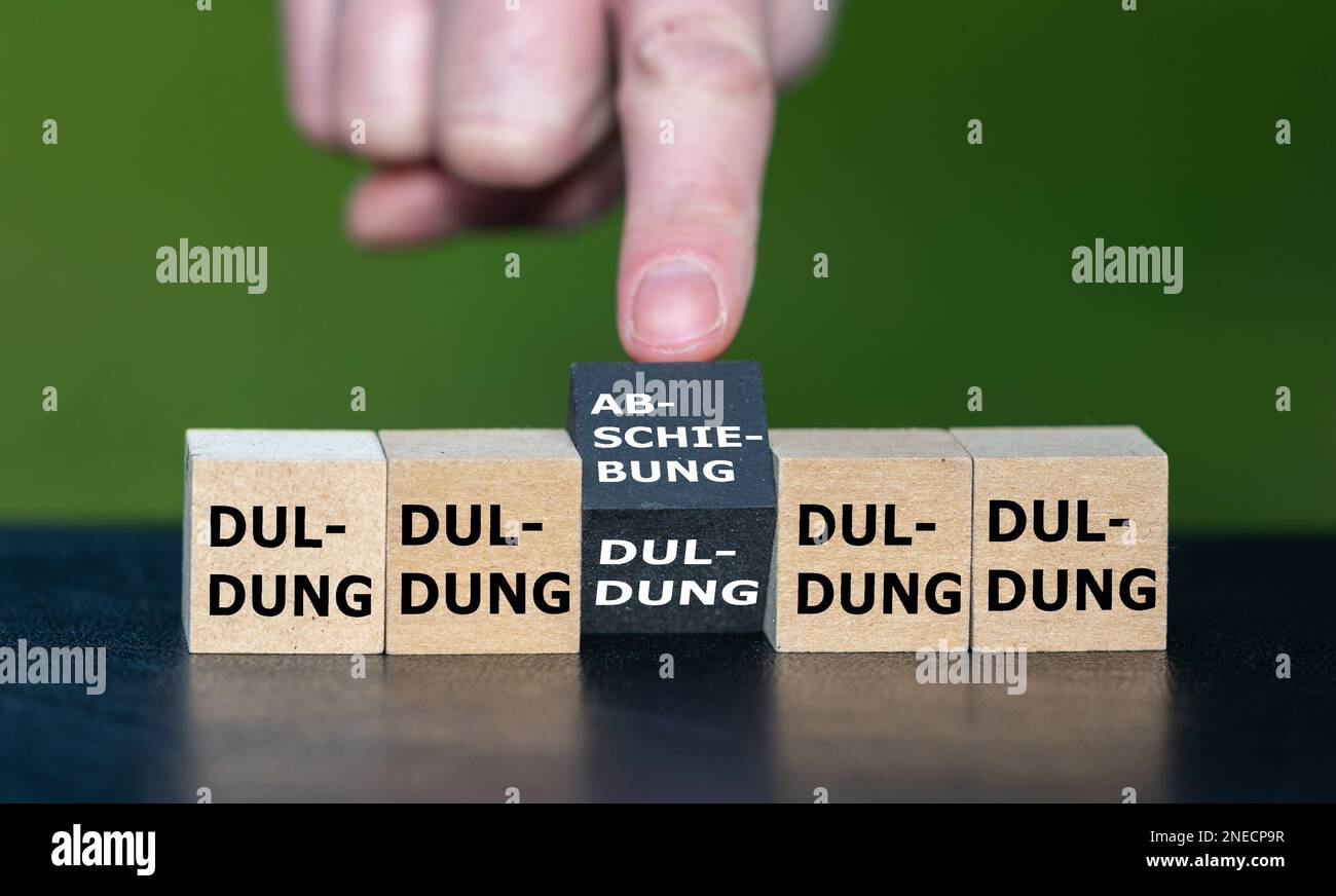 Symbol for deporting asylum seekers. Hand turns one black cube and ...