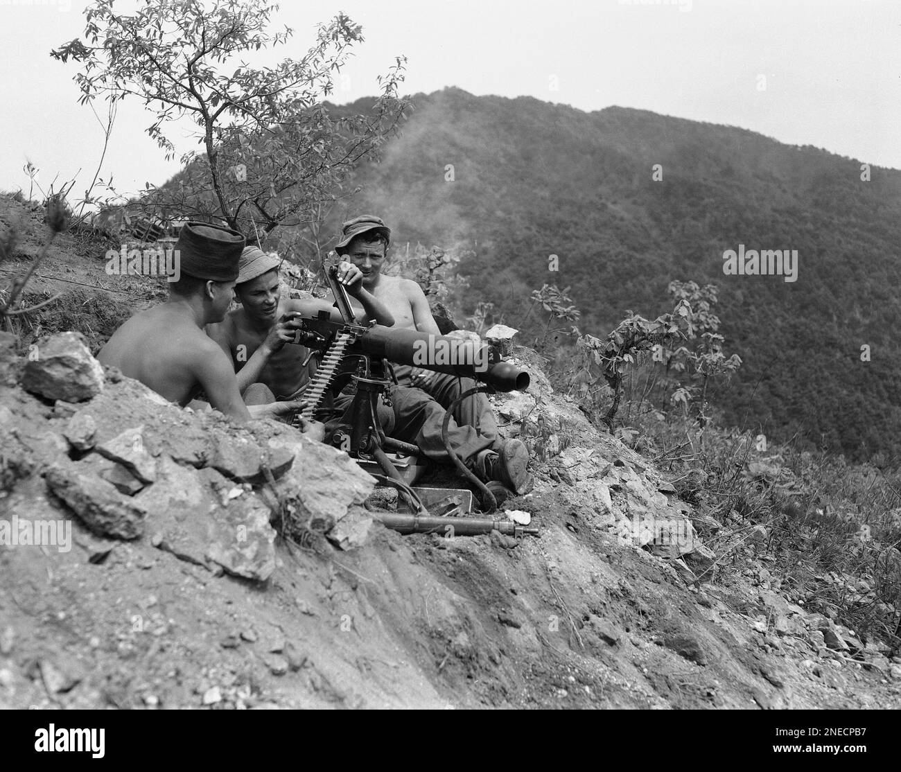 Machine gun crew go through the belt loading mechanism while they wait ...