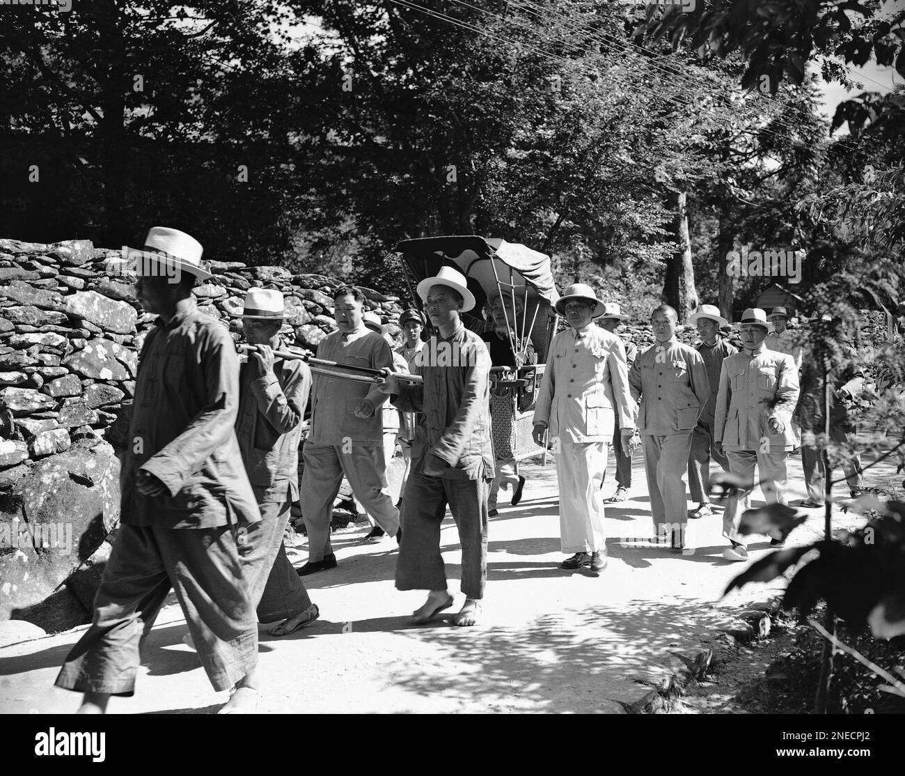 Generalissimo Chiang Kai-Shek, (in sedan chair), arrives at the famous ...