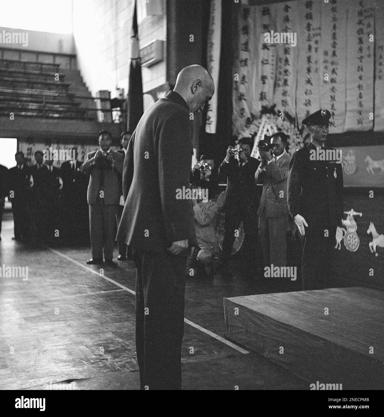 President Chiang Kai-Shek bowing before the portraits of the three ...