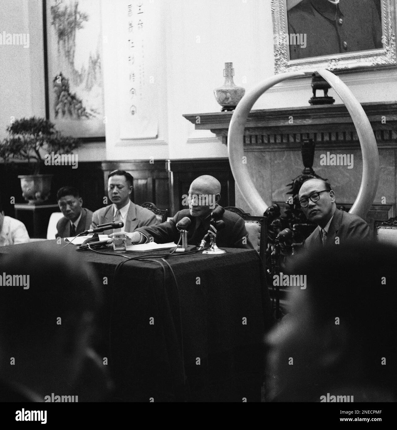 Nationalist Chinese President Chiang Kai-Shek reaches for water glass ...
