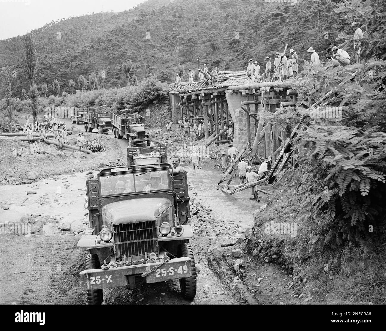 A 25th Division convoy plows through a river gully bypass towards the ...