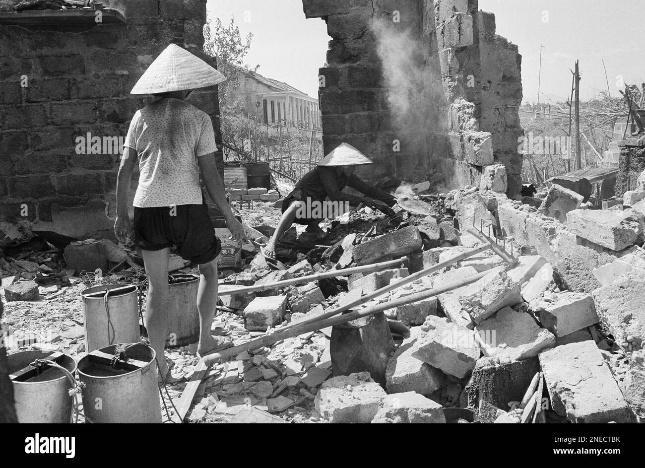 South Vietnamese village women search through ruins of what once was ...