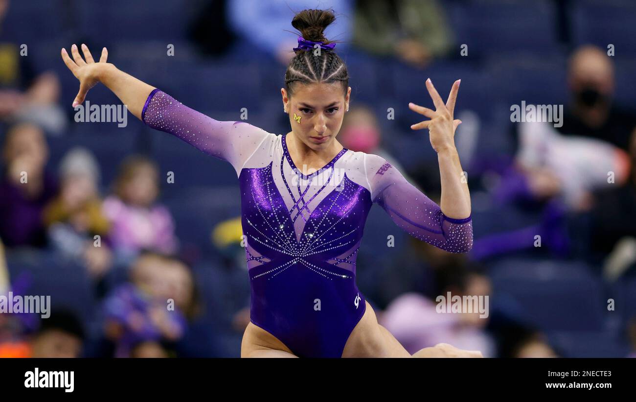 Michigan's Nicoletta Koulos competes in the beam during an NCAA ...