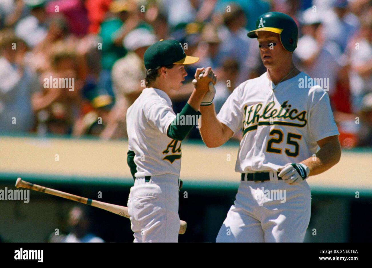 Oakland A?s first baseman Mark McGwire gets five from the bat boy in ...