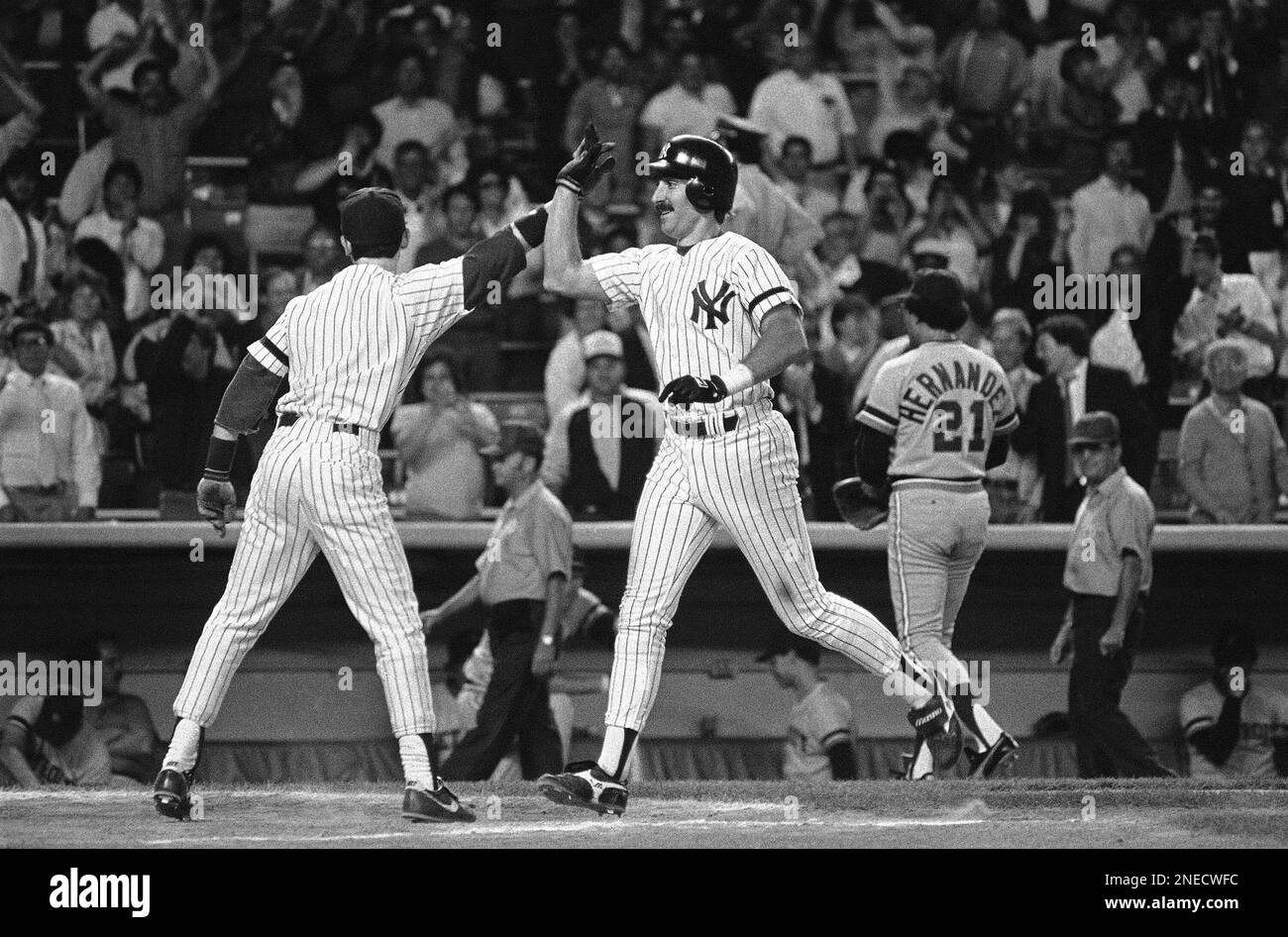 Dale Berra of the New York Yankees high fives as he arrives as home ...