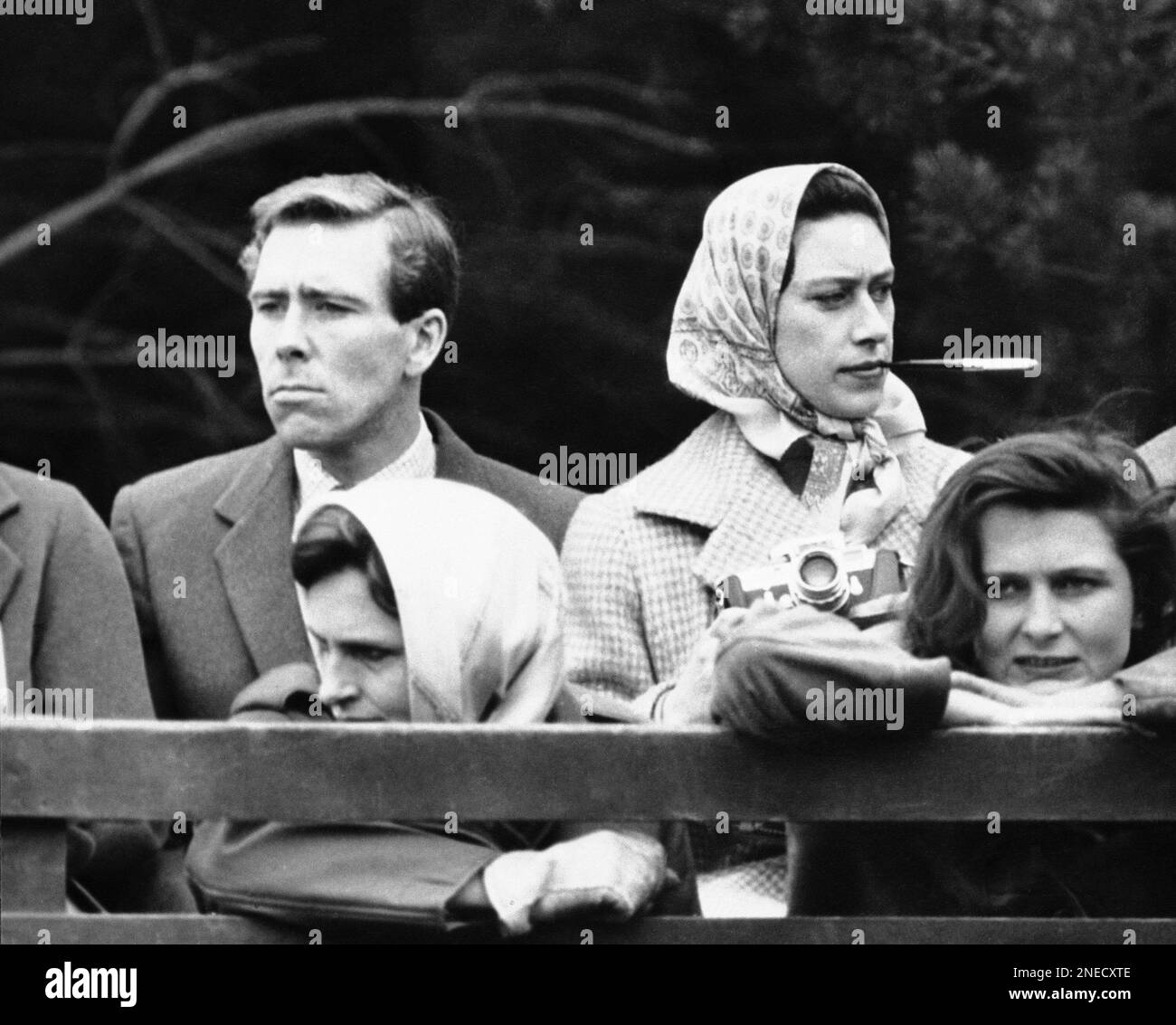 Princess Margaret uses a long cigarette holder as she and her fiancé ...