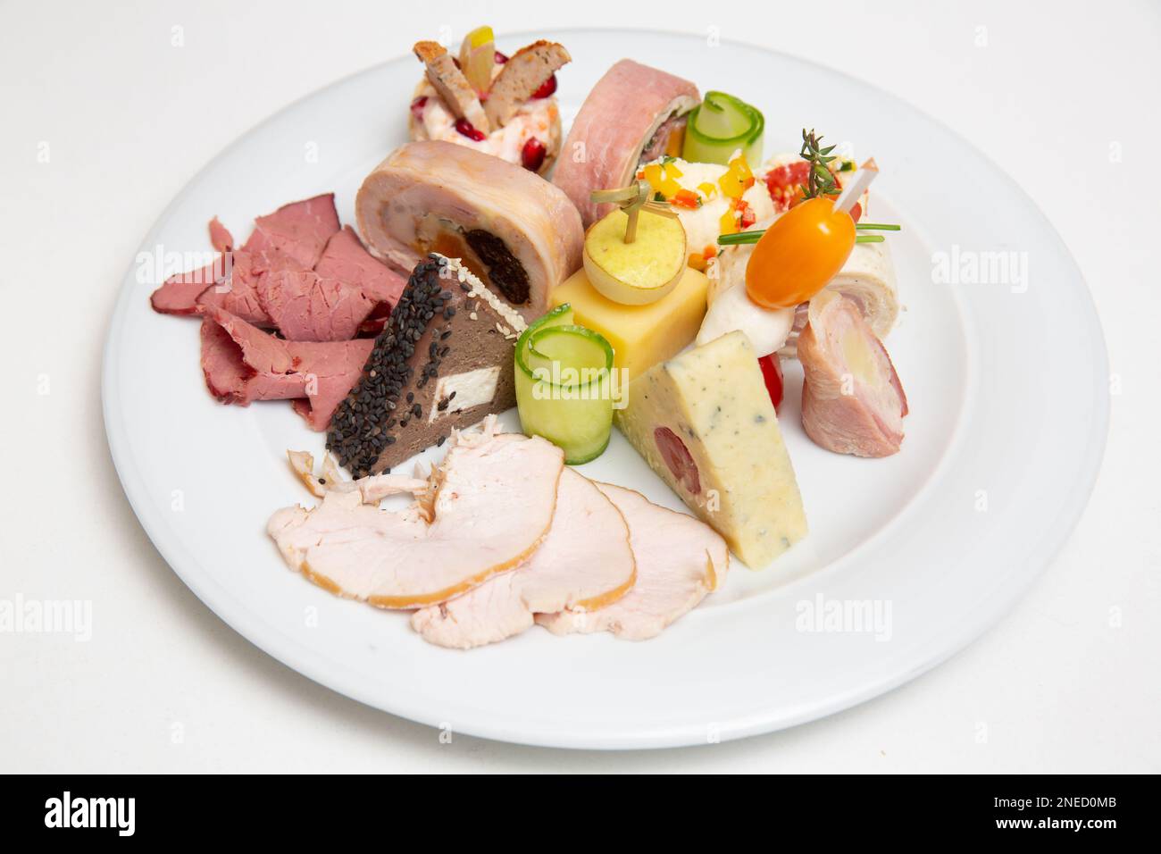 A closeup of a plate with different types of cheese and ham Stock Photo ...