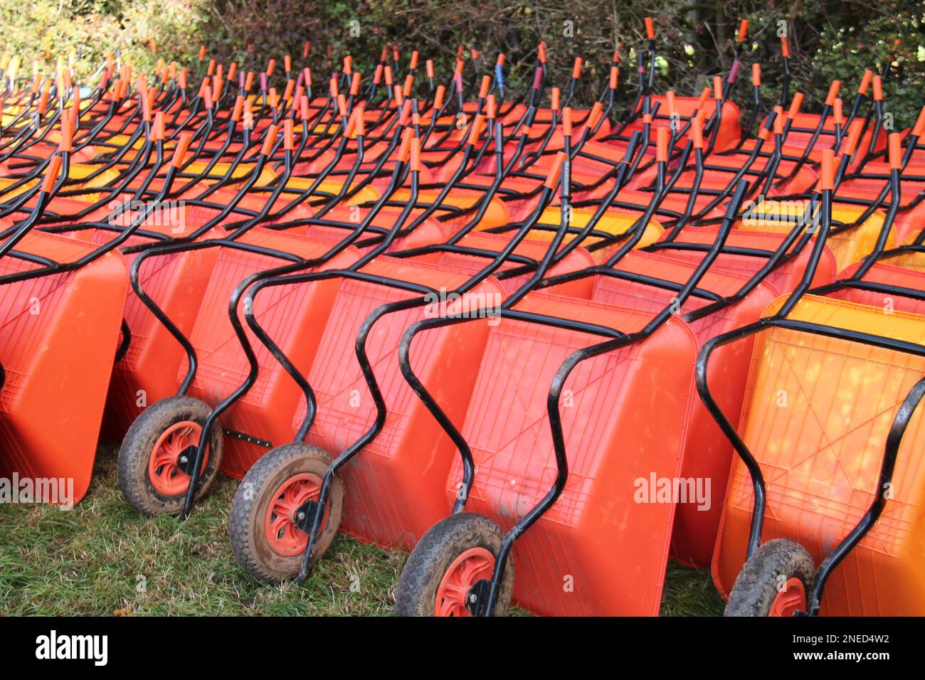 An Outdoor Stack of Orange Plastic Garden Wheelbarrows Stock Photo - Alamy