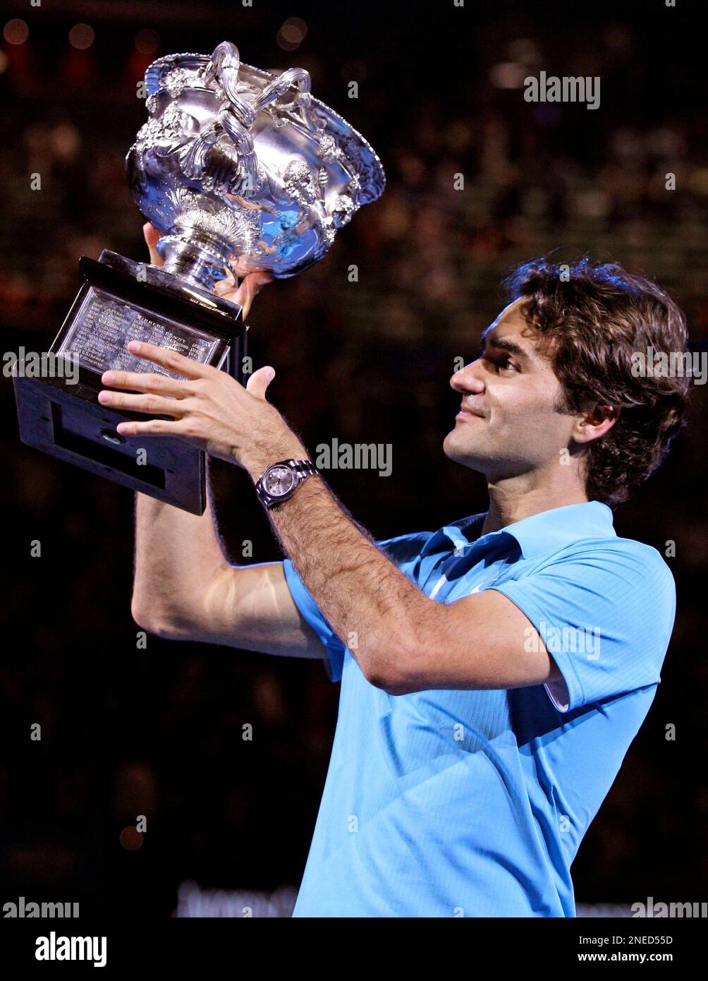 Roger Federer of Switzerland looks up the trophy after beating Andy ...