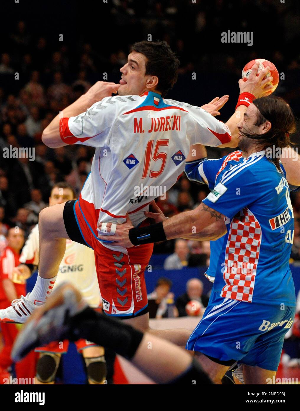 Michal Jurecki of Poland, left, attempts to score past Ivano Balic of ...