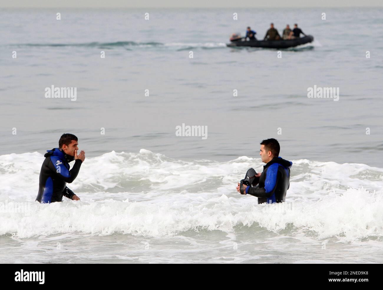 Two Lebanese commando divers search in the sea shore for debris from ...