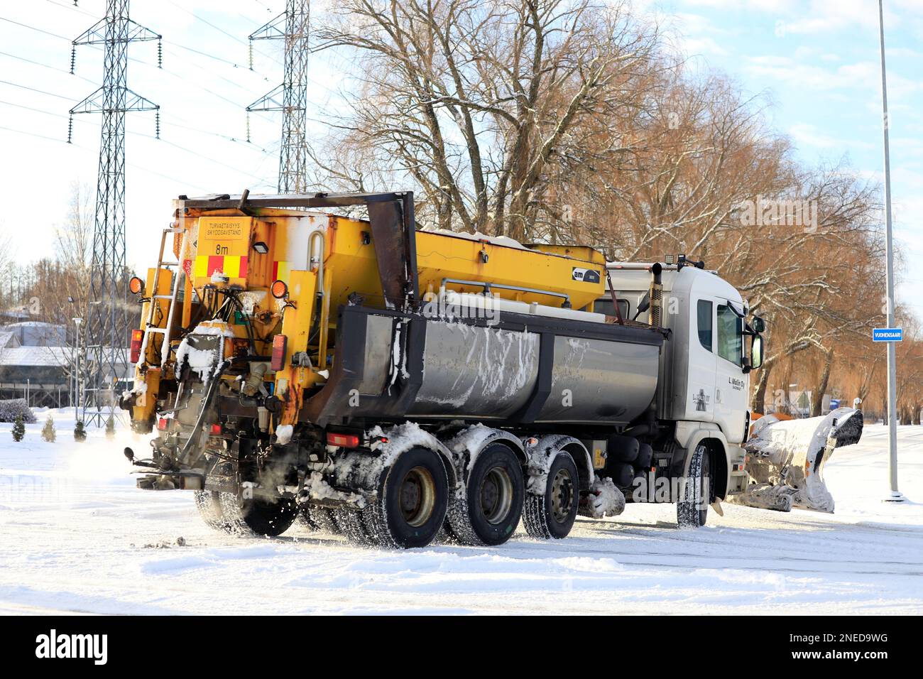 Scania truck equipped with snow plough and road salt spreader on the ...