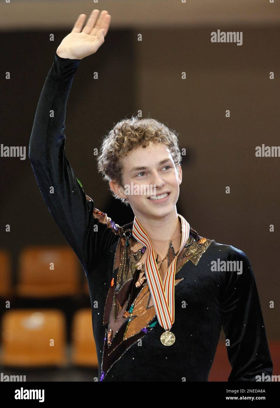 Adam Rippon of the U.S. waves on the podium during the awarding ...
