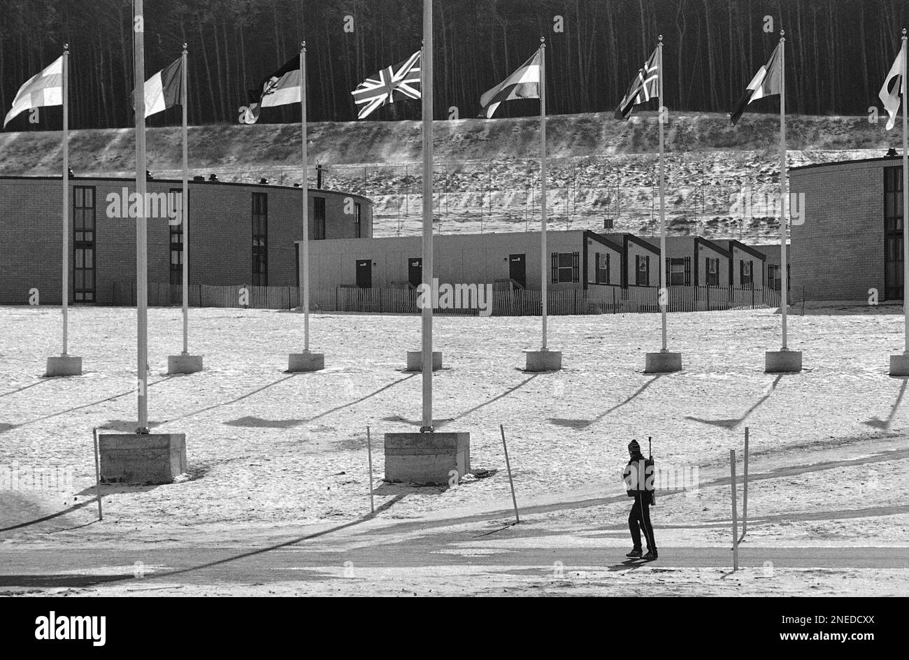 Paul Gibbins, British biathlon entry, carries his 22 caliber gun past ...