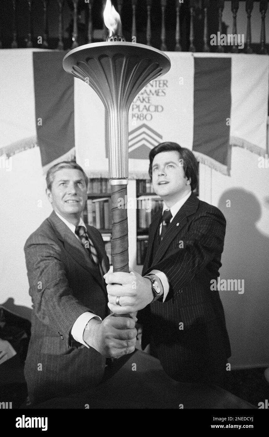 Charles Muirhead, left, and Chris Ortloff hold the official torch for ...