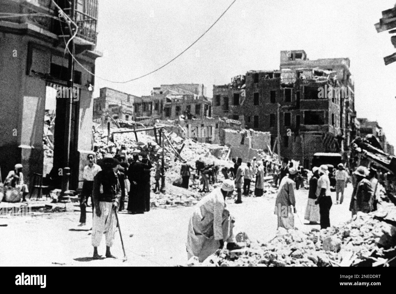 Residents of this British naval base are here seen inspecting the damage to buildings after the ...