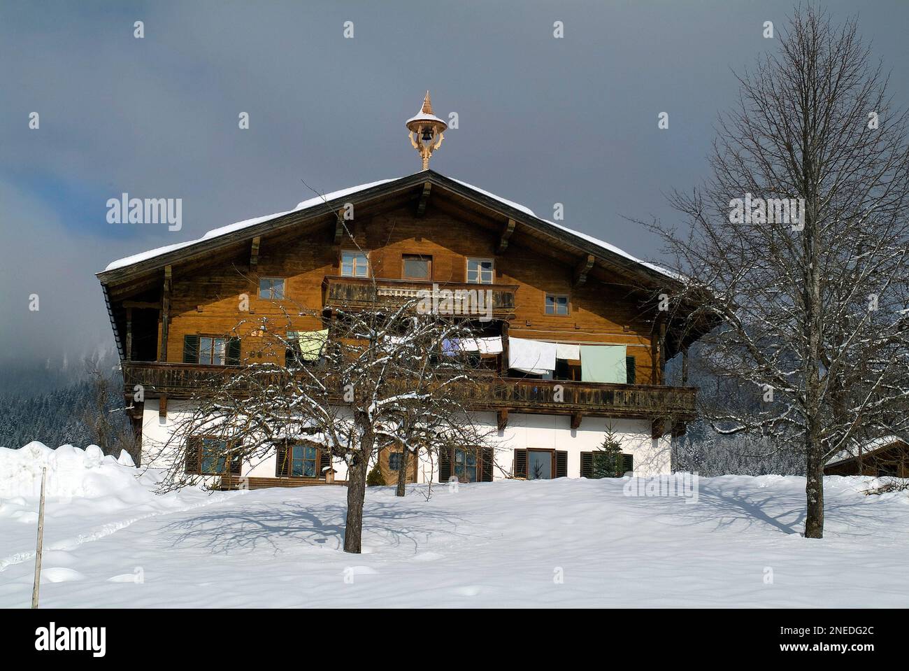 Austria, Tyrol, house of traditional construction with a bell tower in ...