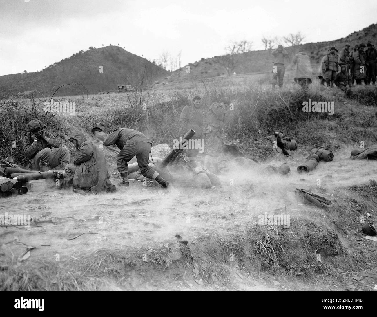 A Marine mortar team fires at enemy positions in Chison sector of Korea ...