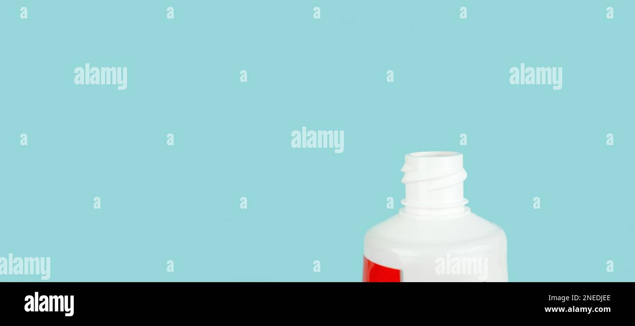 Small Red Toothpaste Tube on blue background. Means to care for the ...
